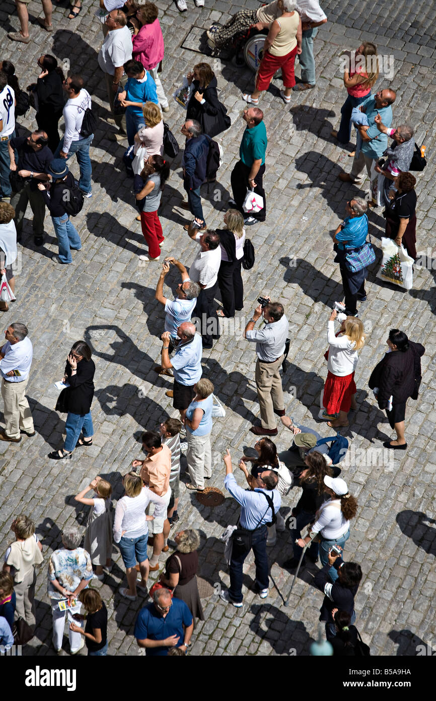 Crowd of people in main square watching clock chime Rothenburg Germany ...
