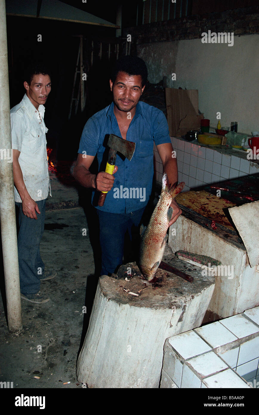 Portrait of man preparing Mazgouf fish Abu Nawas street market Baghdad ...