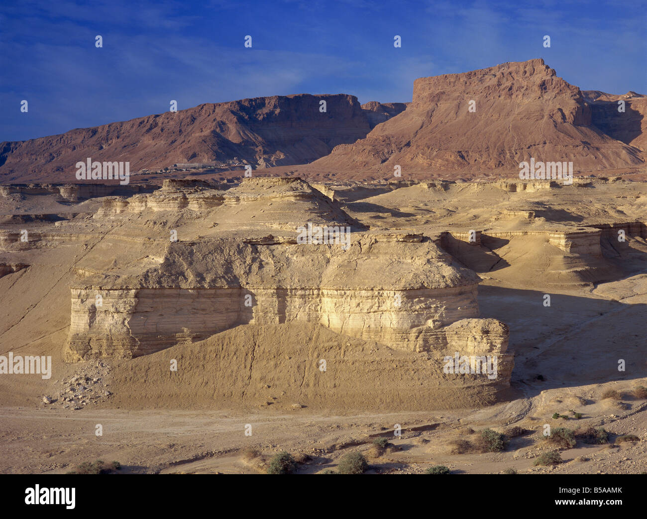 Rock cliffs and sand dunes in front of the fortress of Masada, in the ...
