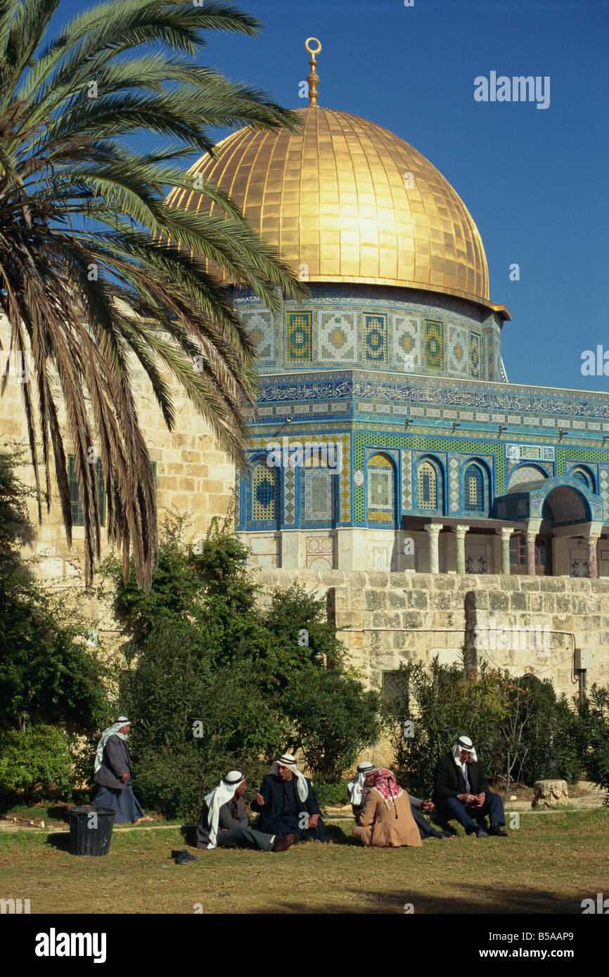 A group of Arab men sit on the grass on Temple Mount, in the Old City ...