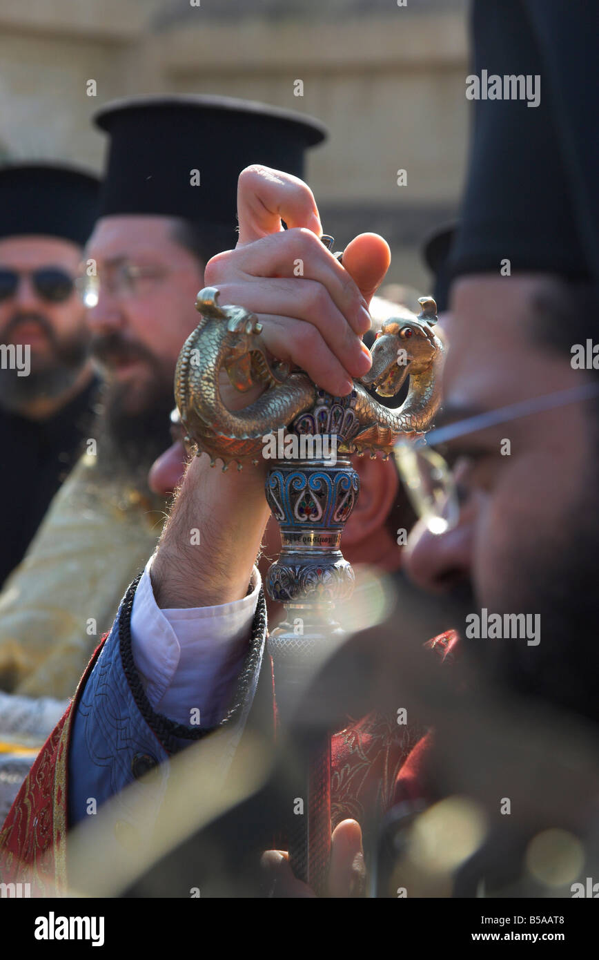 Close up of hand holding decorated ceremonial stick with Orthodox ...