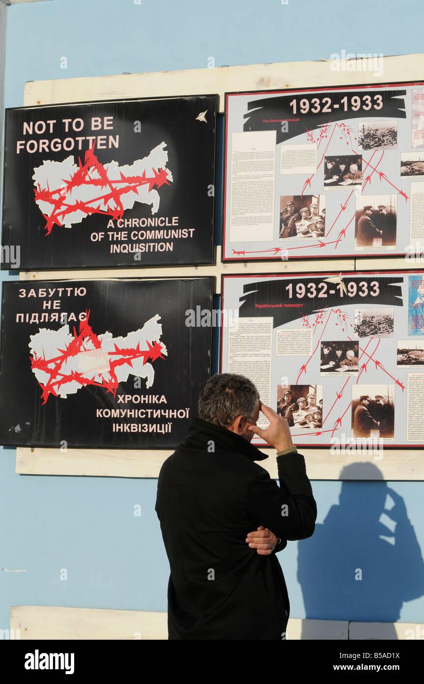 A man looking at a poster describing the history of the Great Famine ...