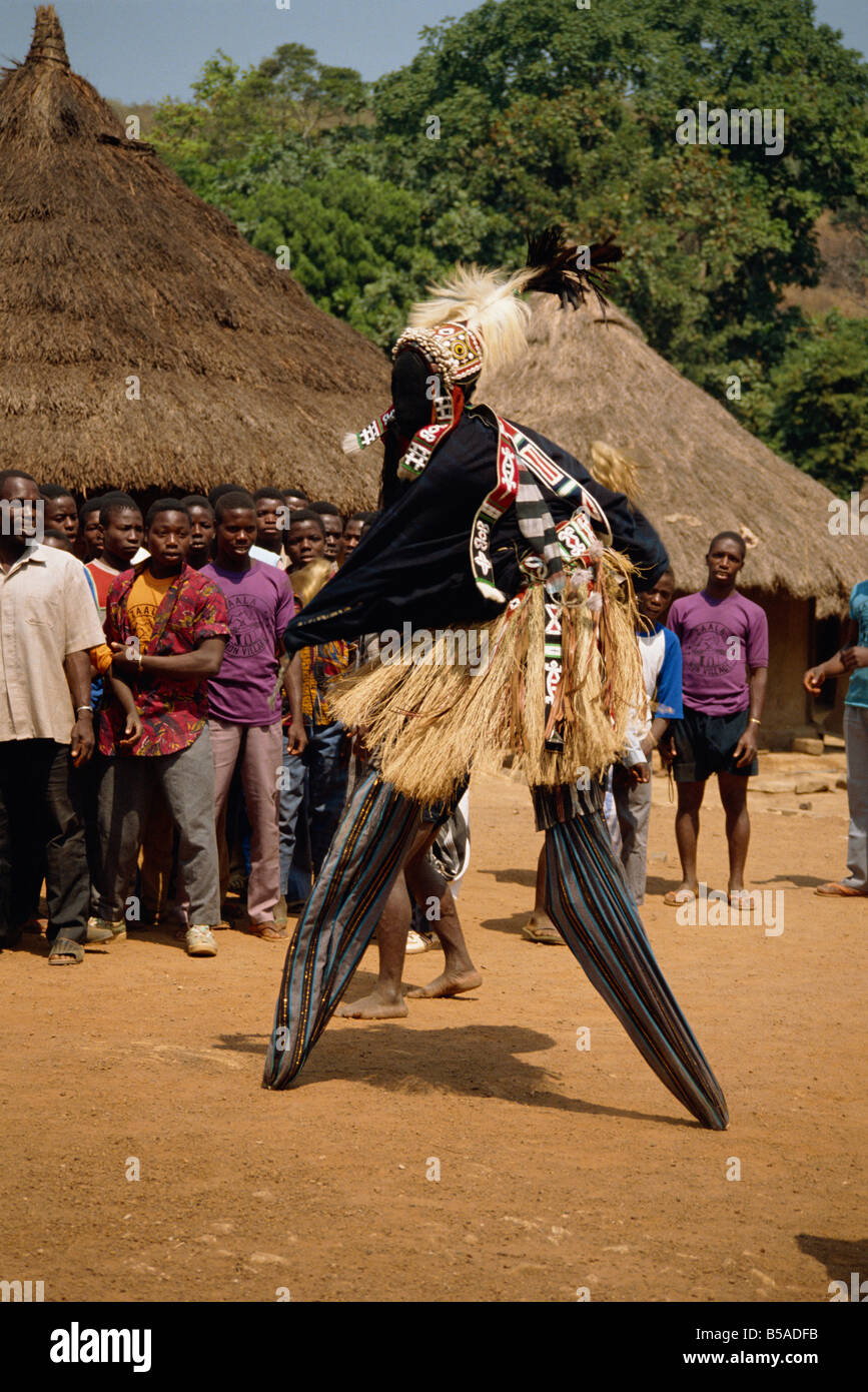 Stilt dancer watched by villagers Ivory Coast Africa D C Poole Stock ...
