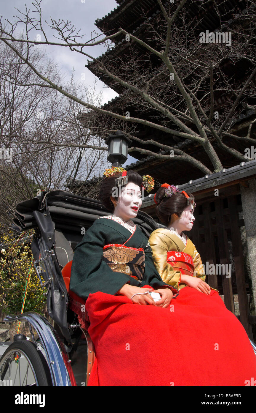 Two geishas in traditional dress posing on a rickshaw, Higashiyama ...
