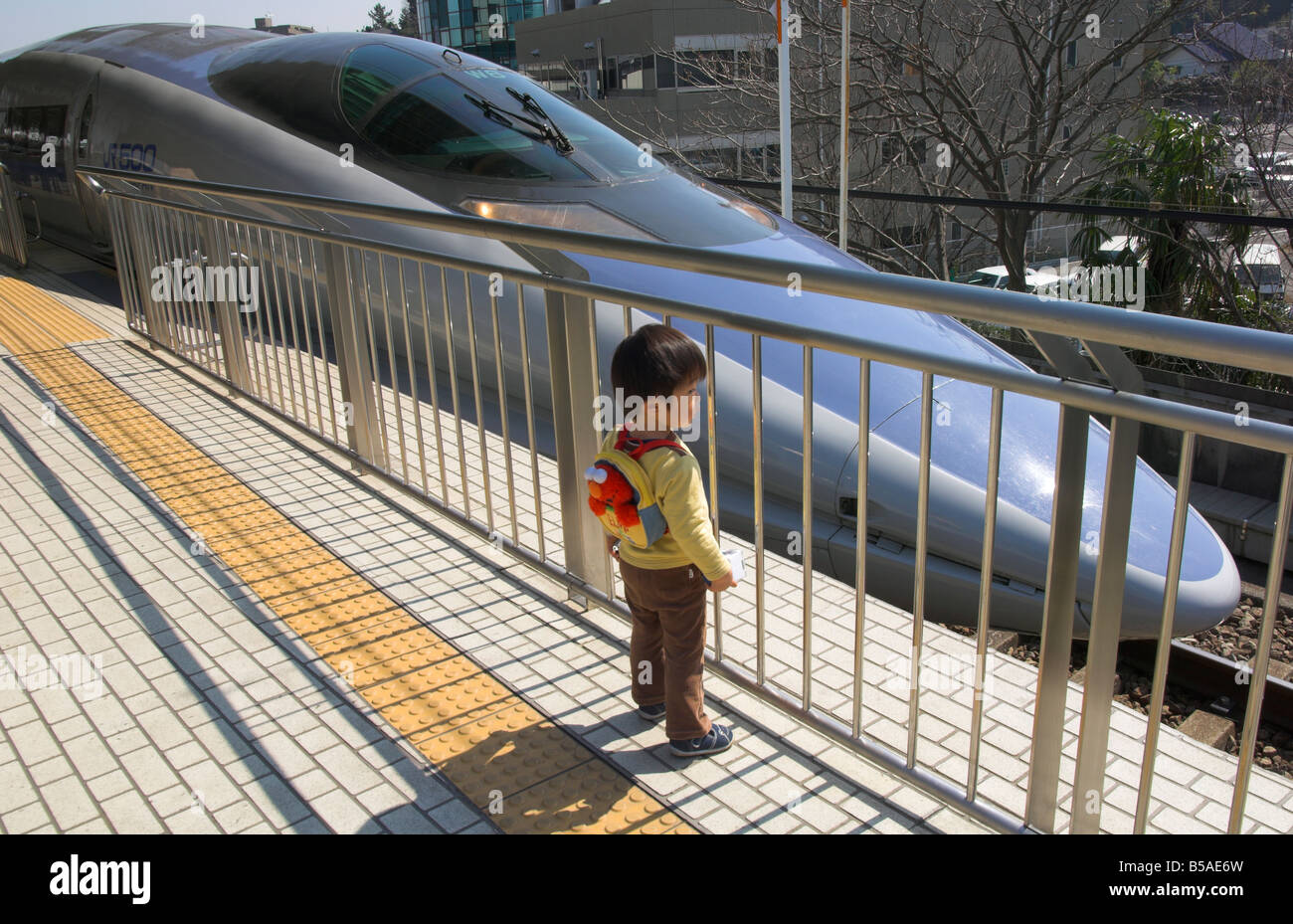 Young child on platform looking at train, Shin Yokohama Shinkansen ...