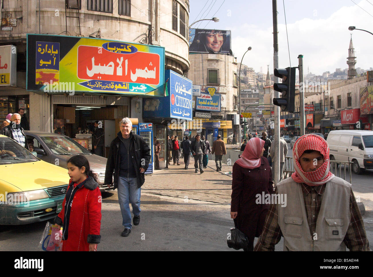 People in street and advertising posters, Basman Street, downtown area ...