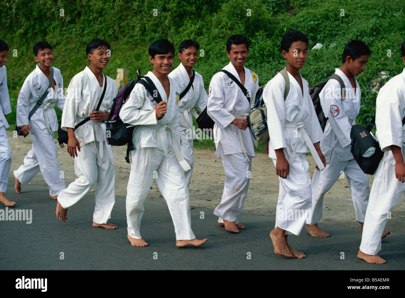 Local young men on their way to outdoor karate practice, Berastagi ...