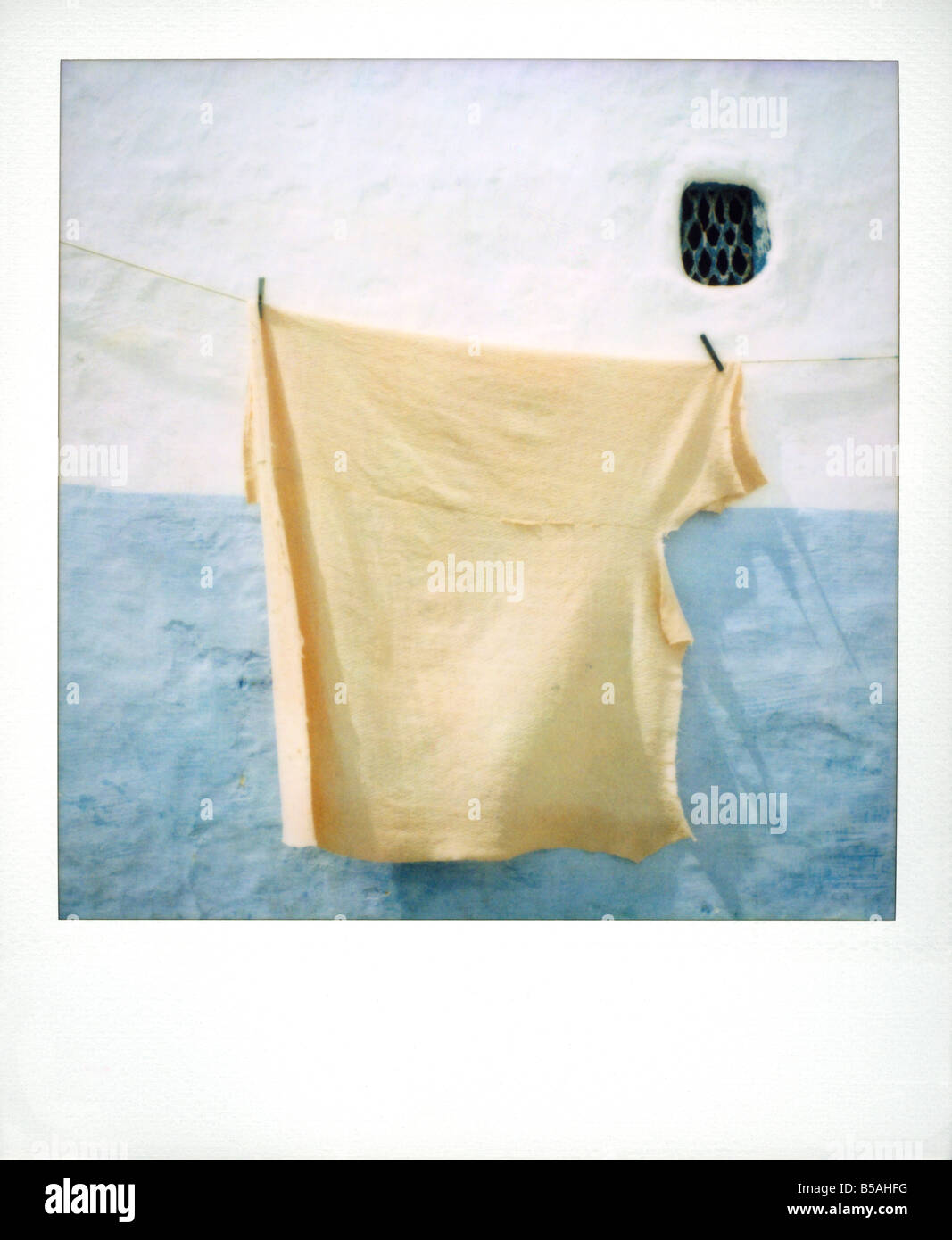 Polaroid image of blanket drying in the sun against white and ...