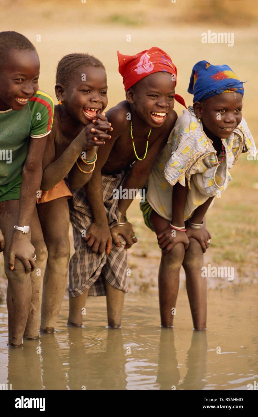 Group of young children smiling paddling in the Niger River Mali Africa ...