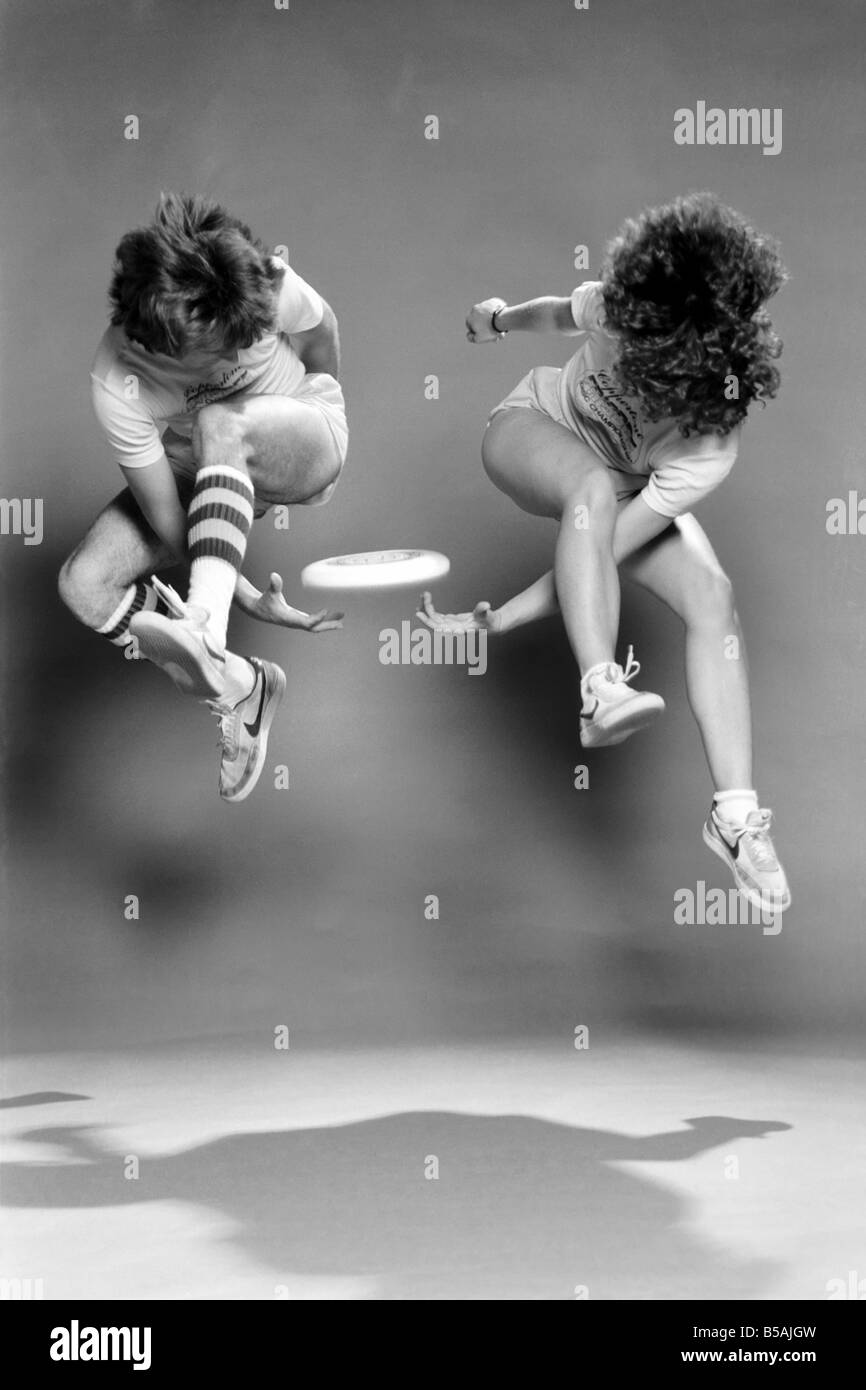 A man and woman performing exercises with a frisbee. June 1980 Stock ...