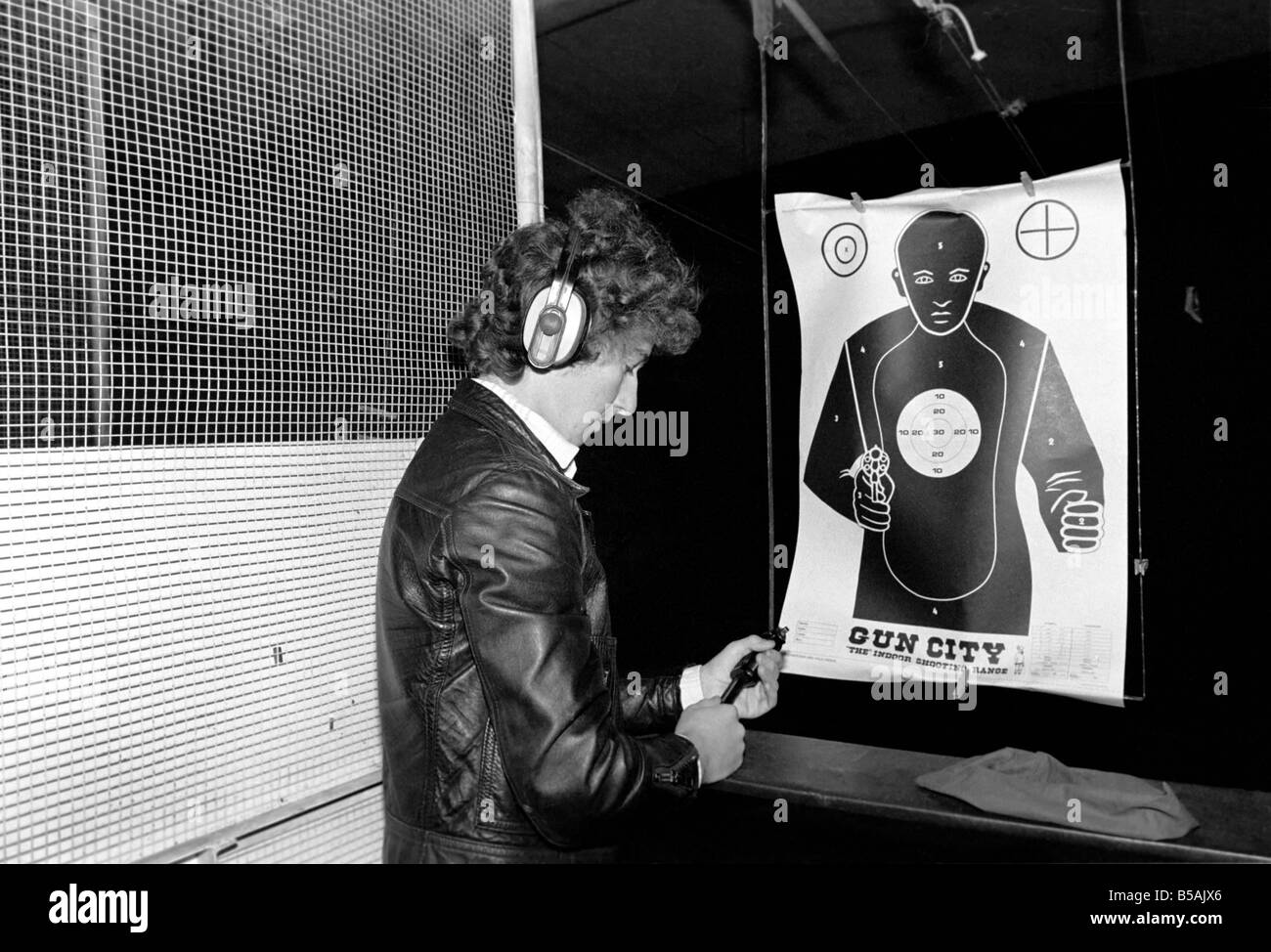 A man shooting at a target during practice at Gun City shooting range ...