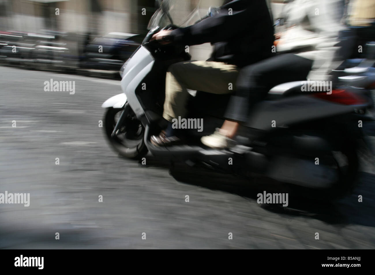 two people riding scooter moped in rome italy Stock Photo - Alamy