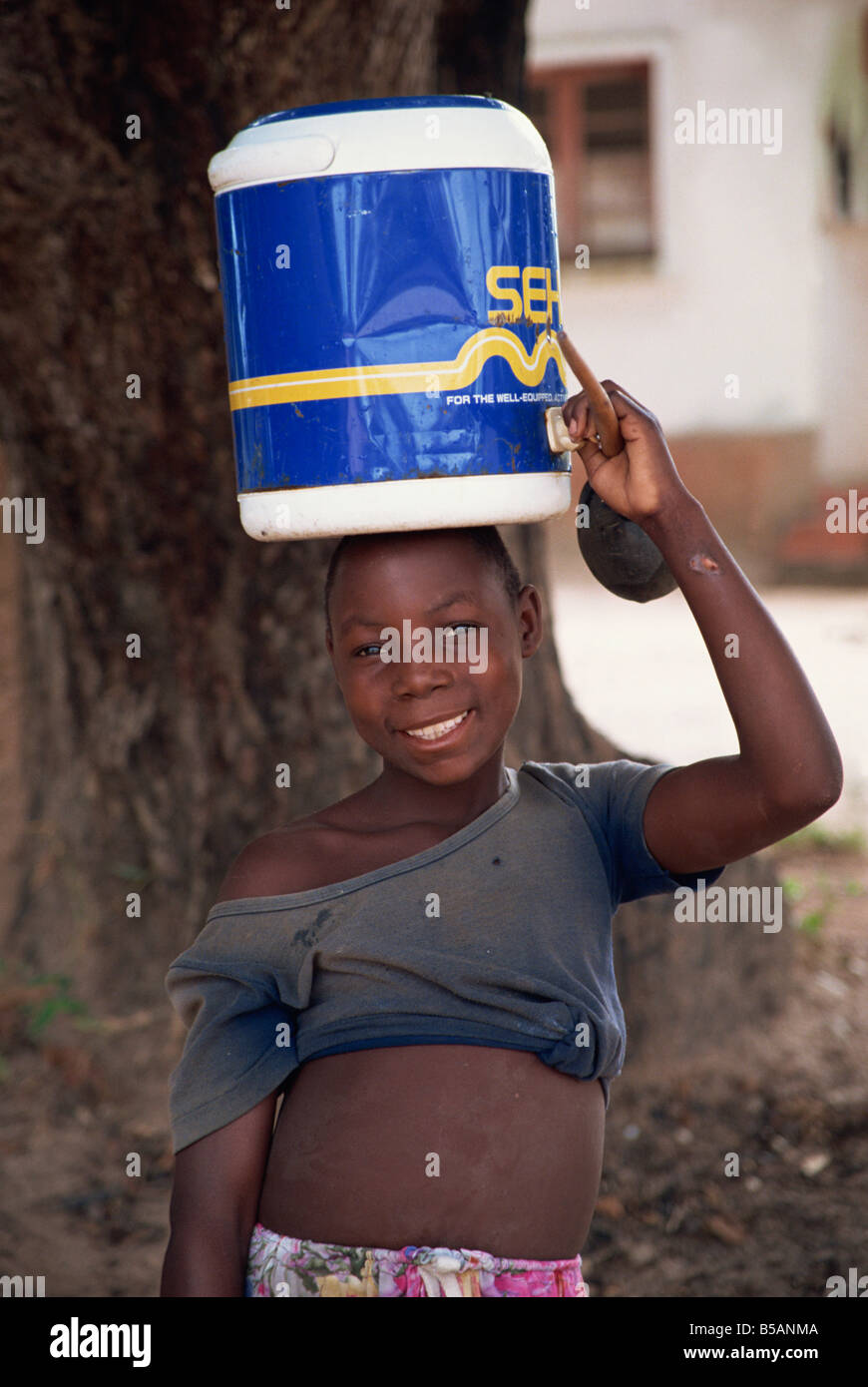 Girl carrying water on her head Mozambique Africa L Taylor Stock Photo ...