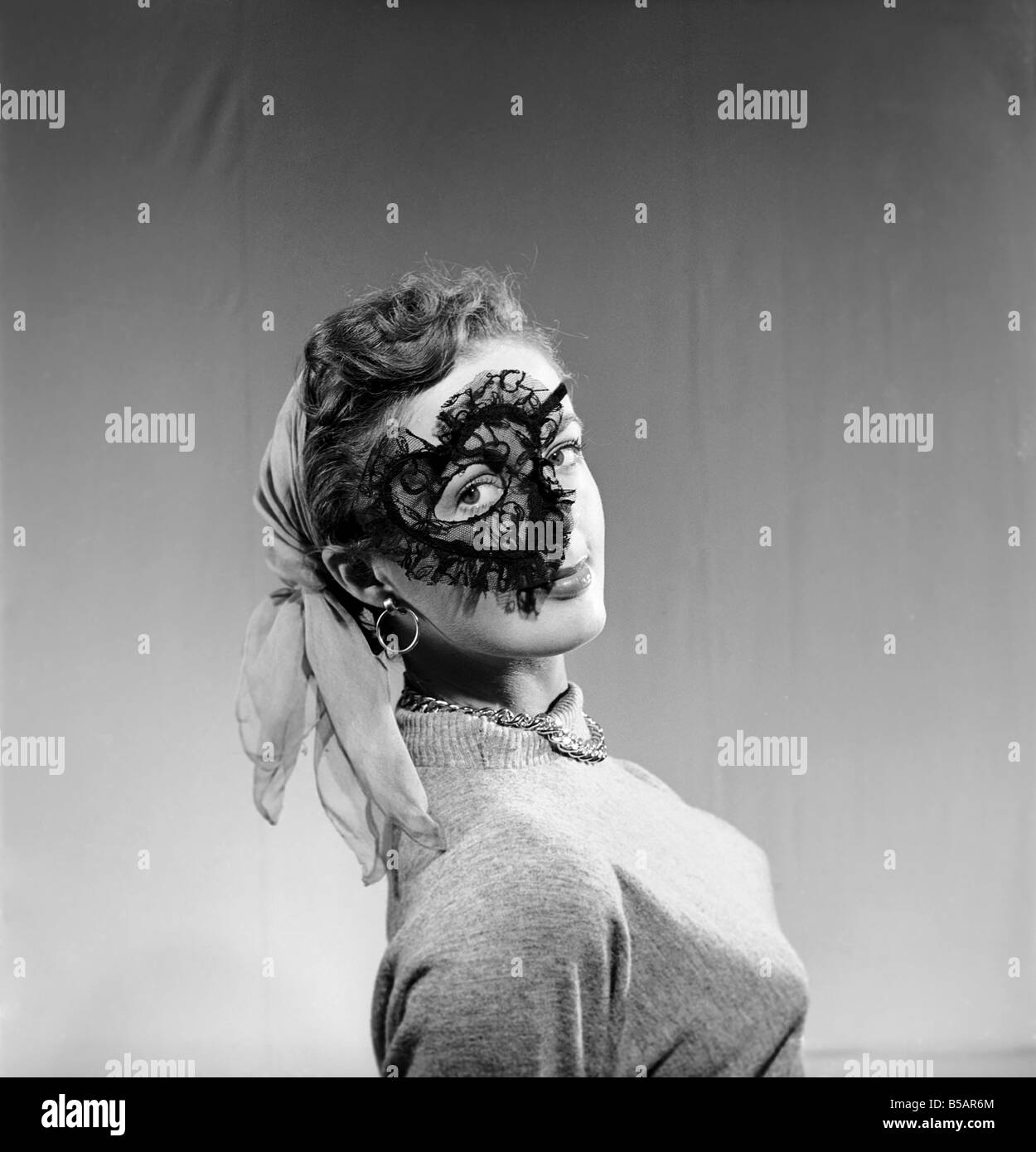 Clothing: Woman wearing party mask. 1955 B89-001 Stock Photo - Alamy