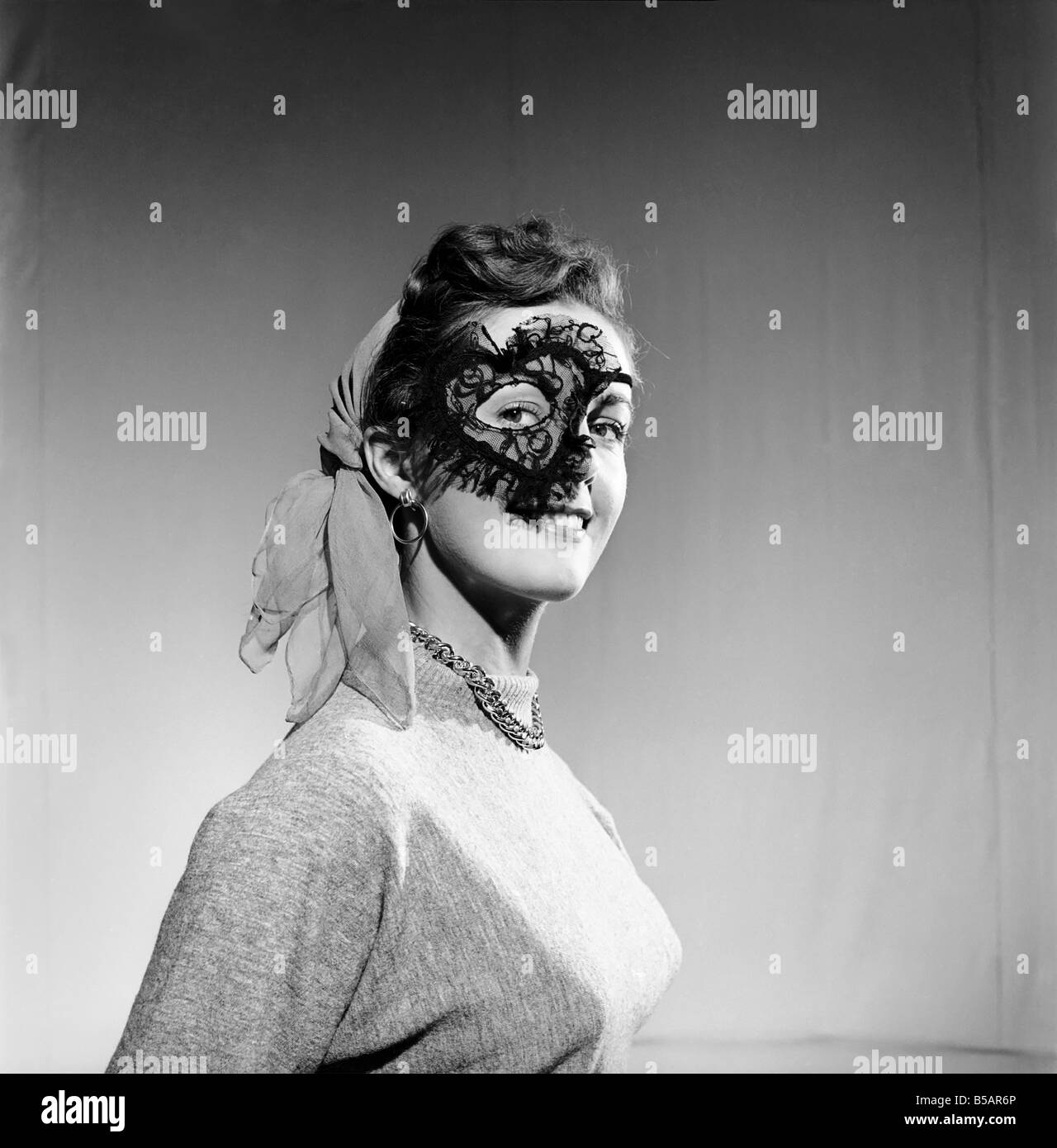 Clothing: Woman wearing party mask. 1955 B89-002 Stock Photo - Alamy
