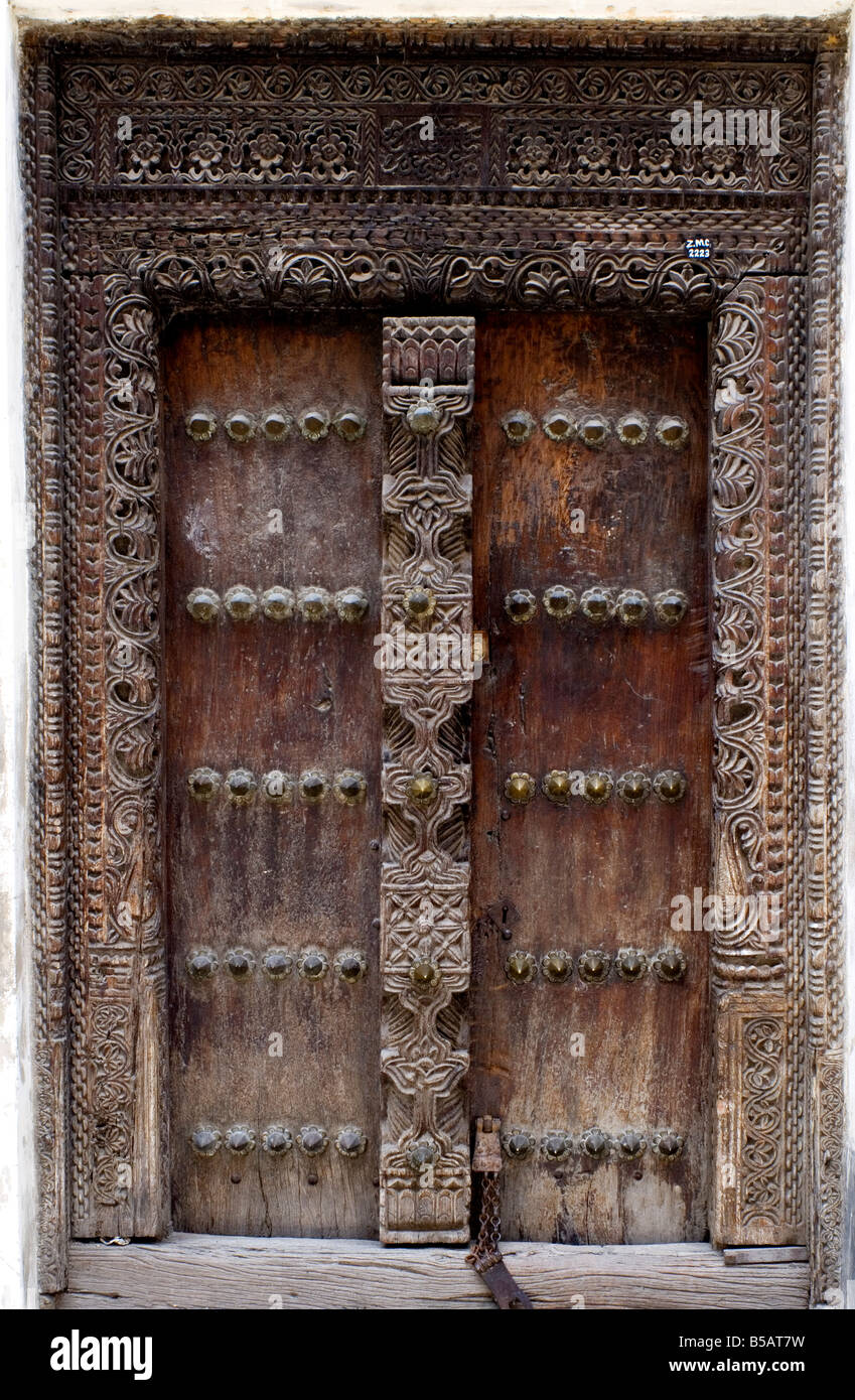 An intricately carved wooden Arab door in Stone Town Zanzibar Tanzania ...