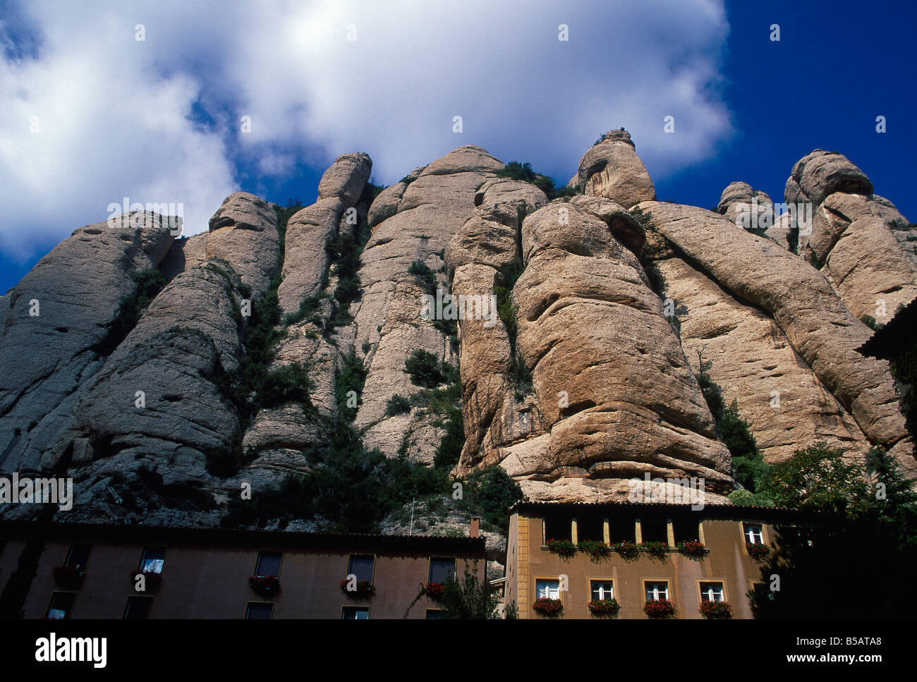 Serrated mountain Rounded eroded towers of rock Monastery nestling ...
