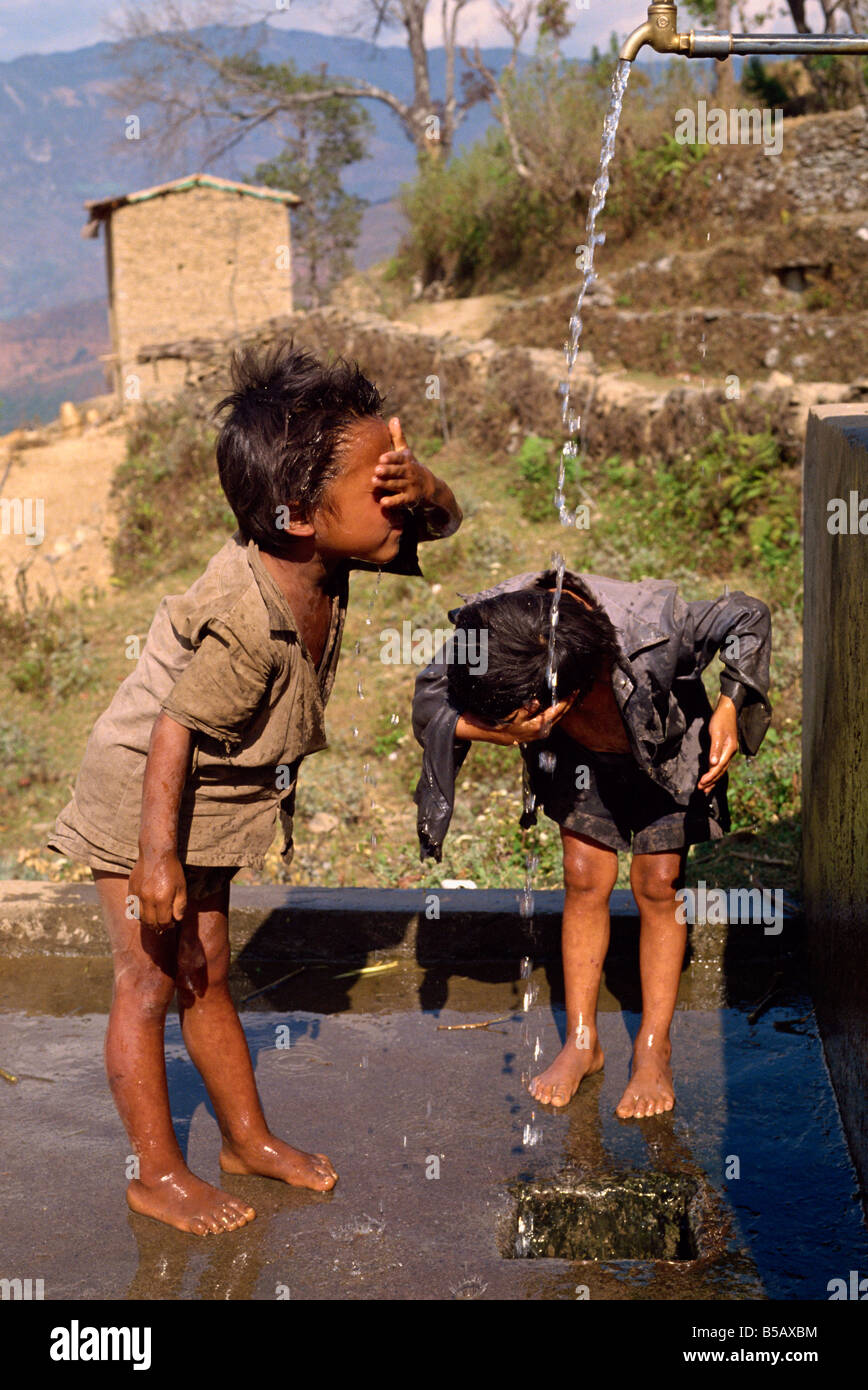 Two children washing at the school funded by Save the Children at ...