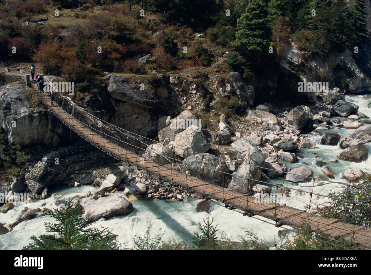 Trekkers crossing rope bridge in Everest Region Nepal Asia A Wright ...