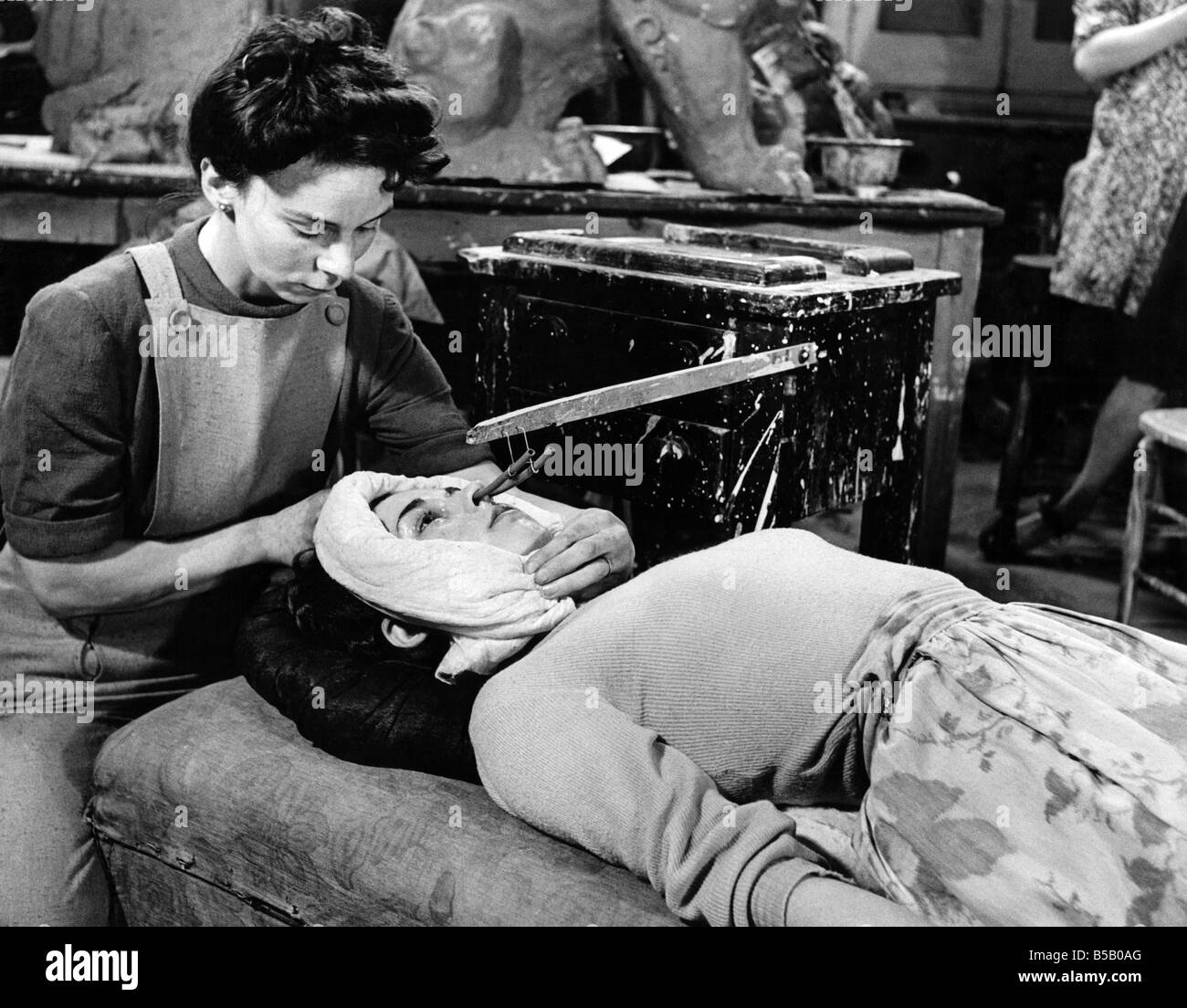 Daphne Lee arranges a protective cloth to save the plaster going on to ...