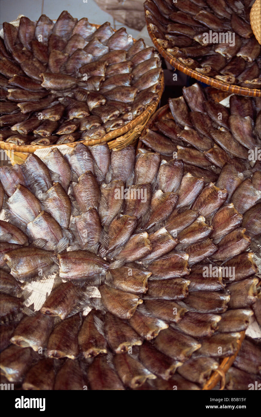 Fish laid out in patterns in baskets in a street market in Bangkok ...