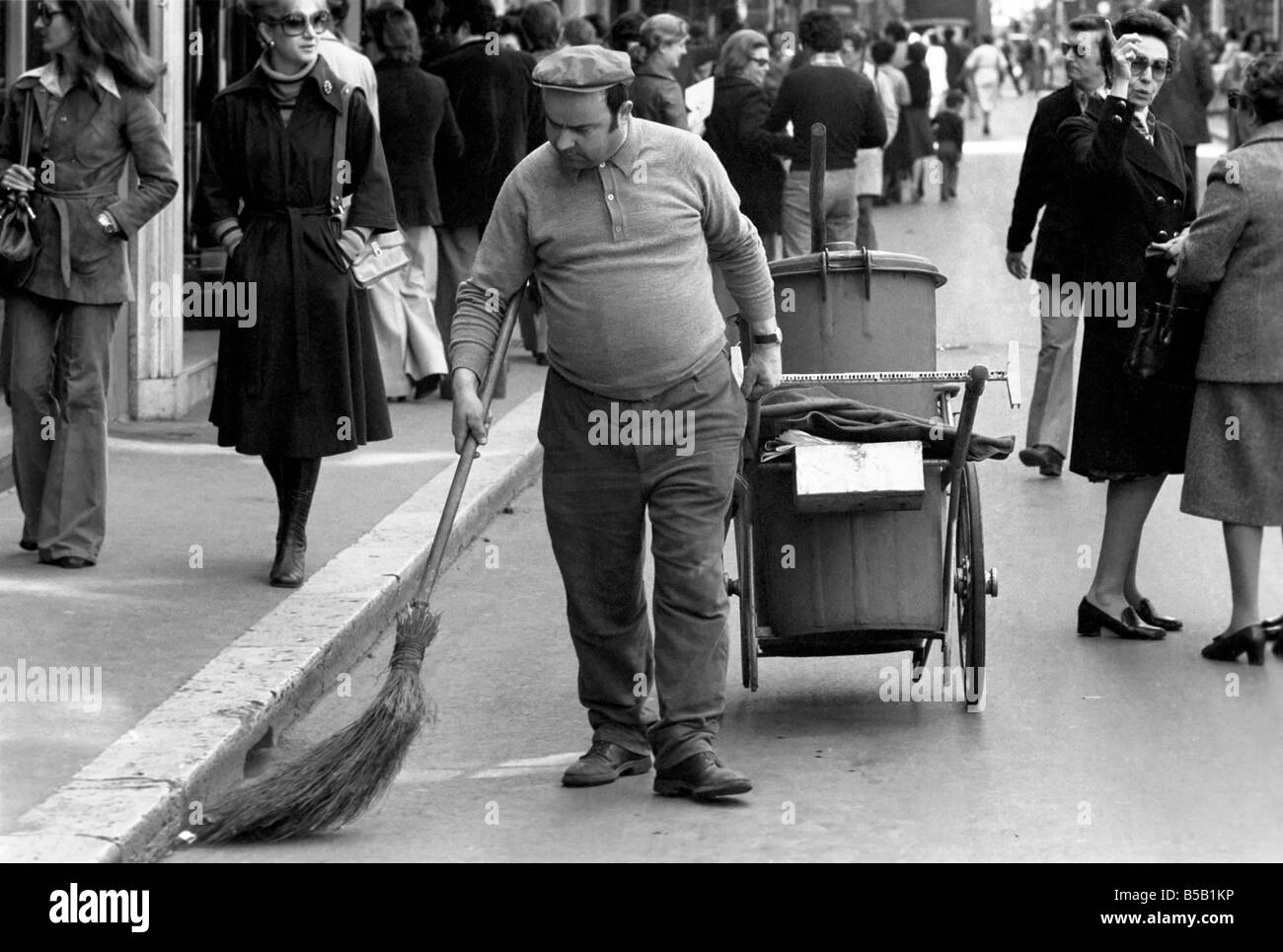 A road sweeper cleaning the streets in a poor suburb on the outskirts ...