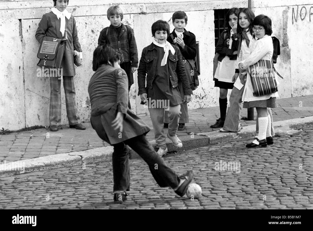 Children playing football on the streets in a poor suburb on the ...