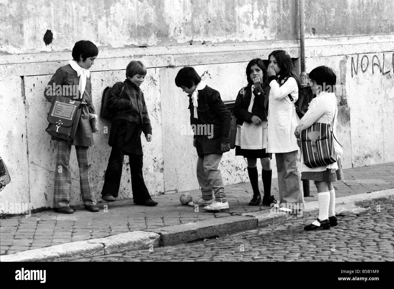 Children playing football on the streets in a poor suburb on the ...