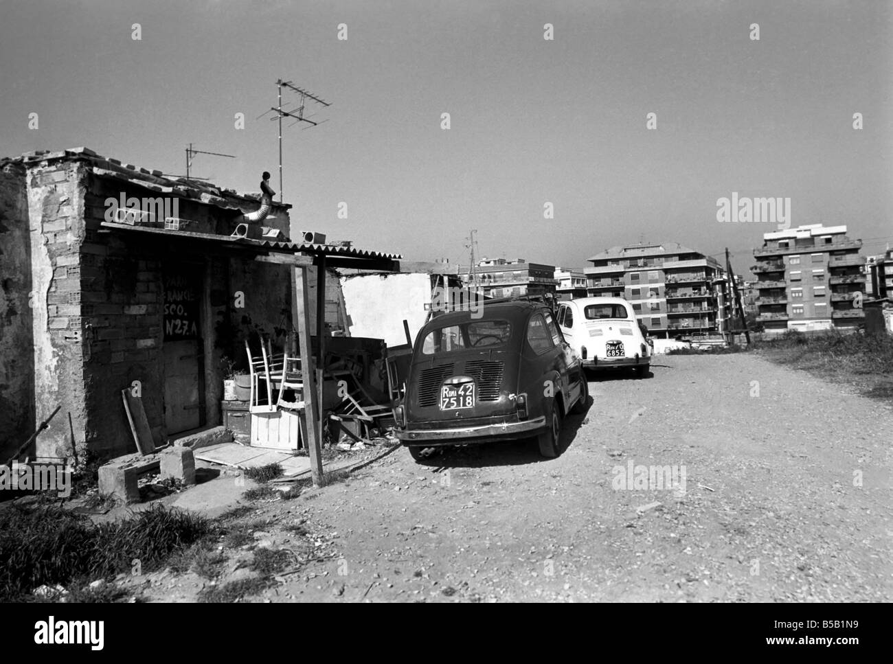 Housing and motor cars in a poor suburb on the outskirts of Rome, Italy ...