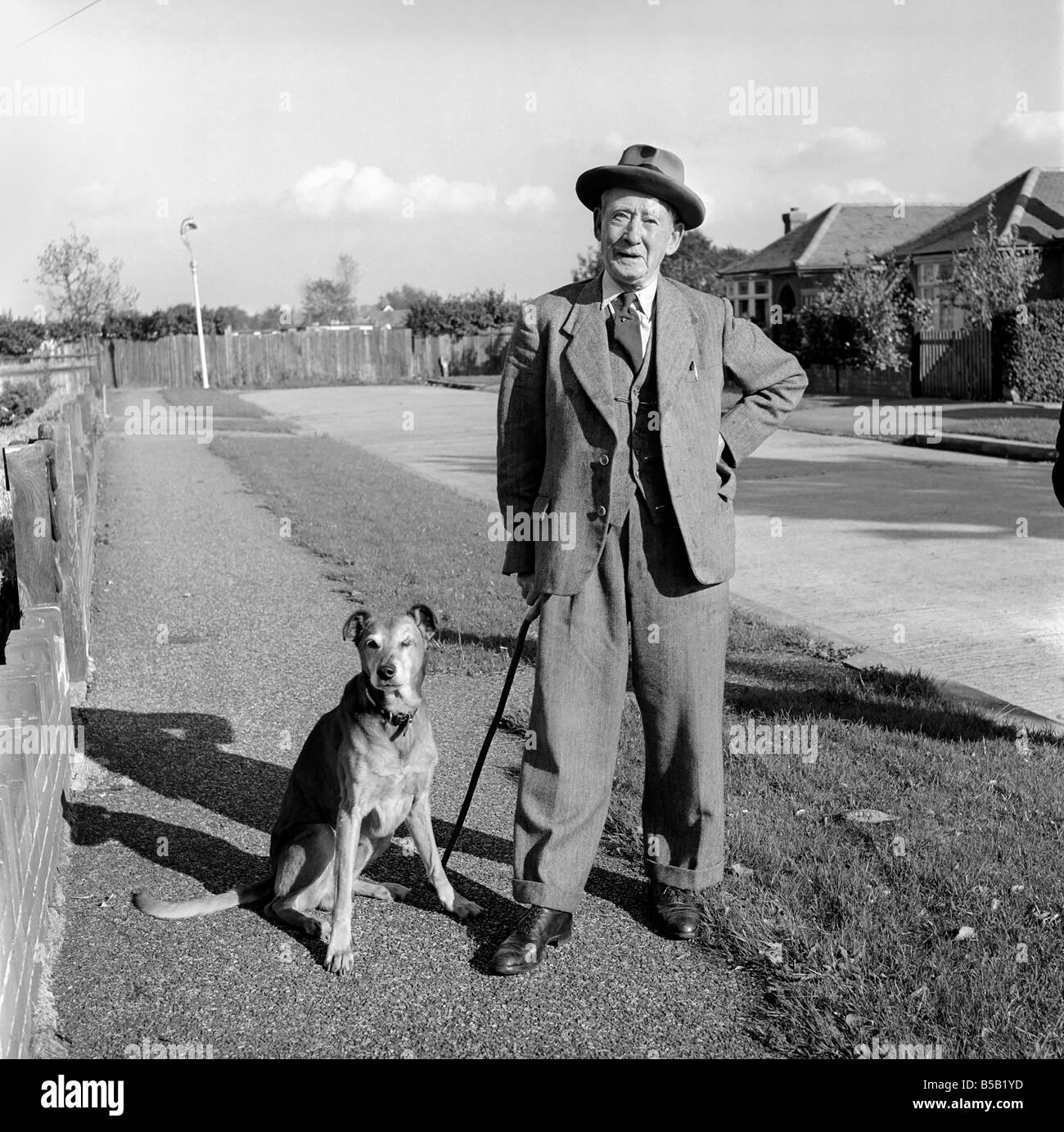 Man's best friend: Man walking a dog. Circa 1954 Stock Photo - Alamy