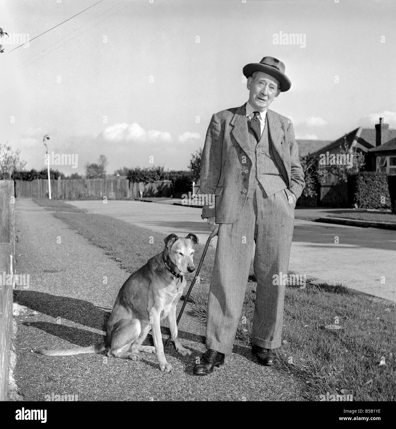 Man's best friend: Man walking a dog. Circa 1954 Stock Photo - Alamy