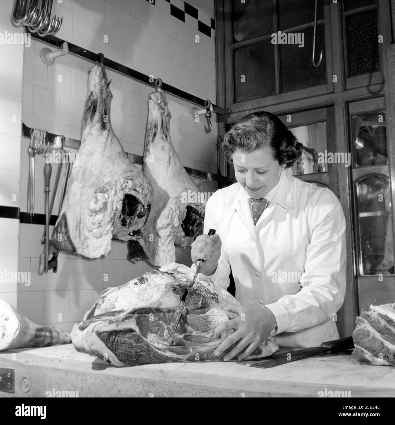 Woman butcher seen here at work. 1954 Stock Photo - Alamy