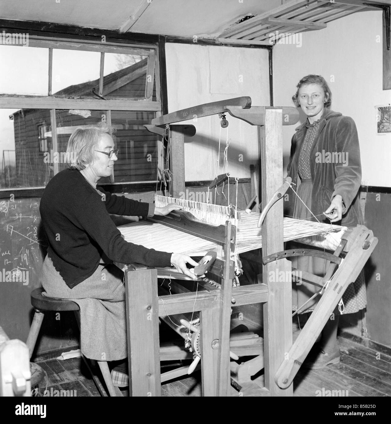Woman seen here working at a loom weaving. 1955 Stock Photo - Alamy