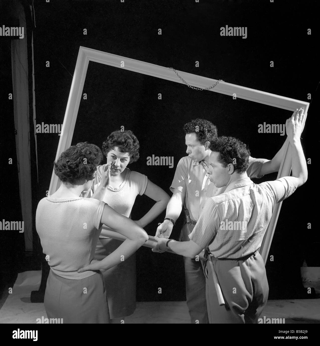 Mirror image: A couple argue in front of a mirror. 1958 Stock Photo - Alamy