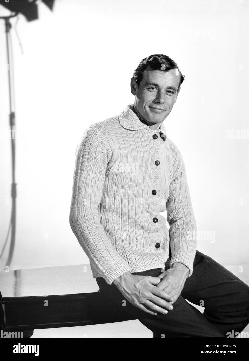 Model John Handy wearing cardigan in Reveille Studio . 1960 Stock Photo ...