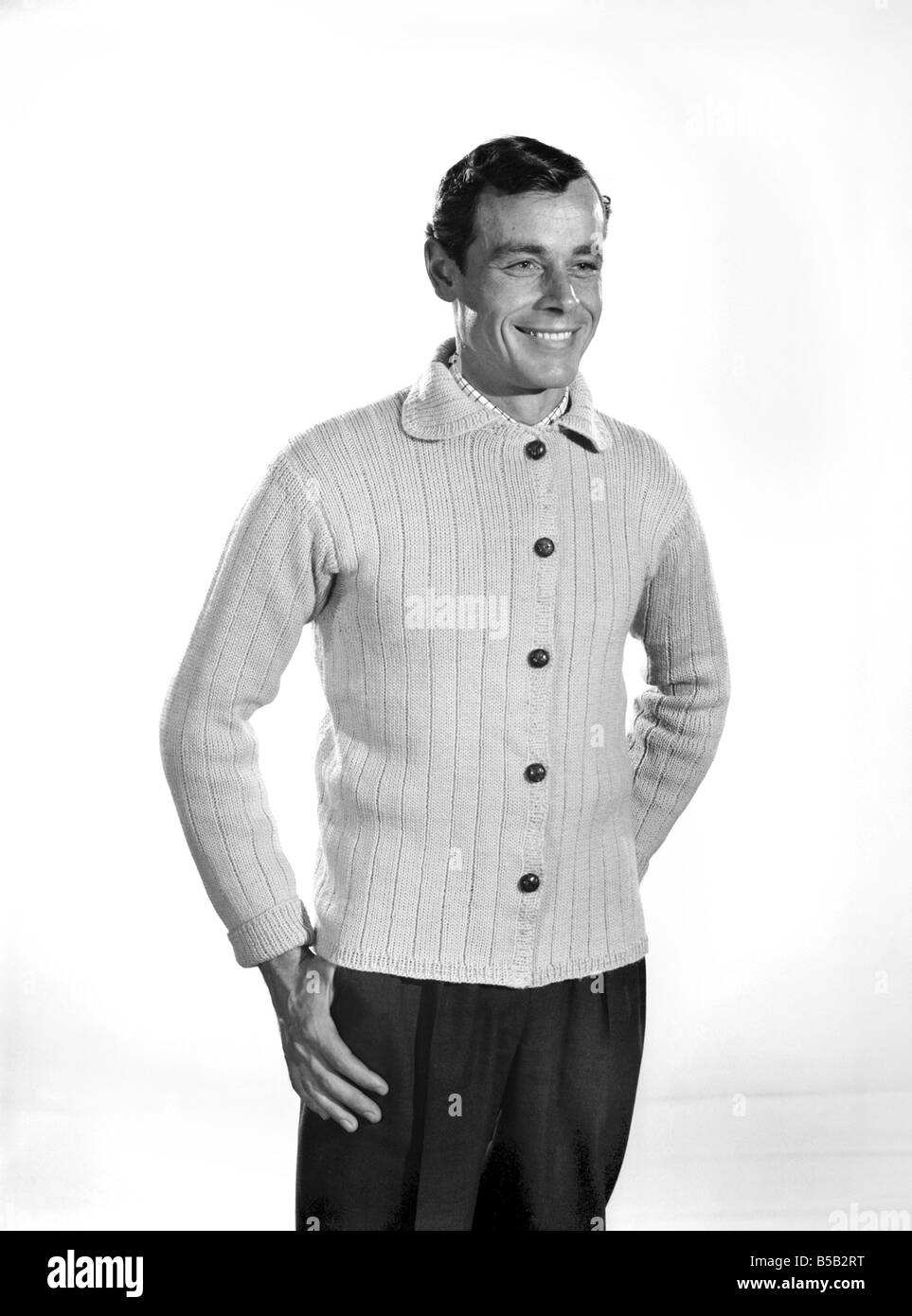Model John Handy wearing cardigan in Reveille Studio . 1960 Stock Photo ...