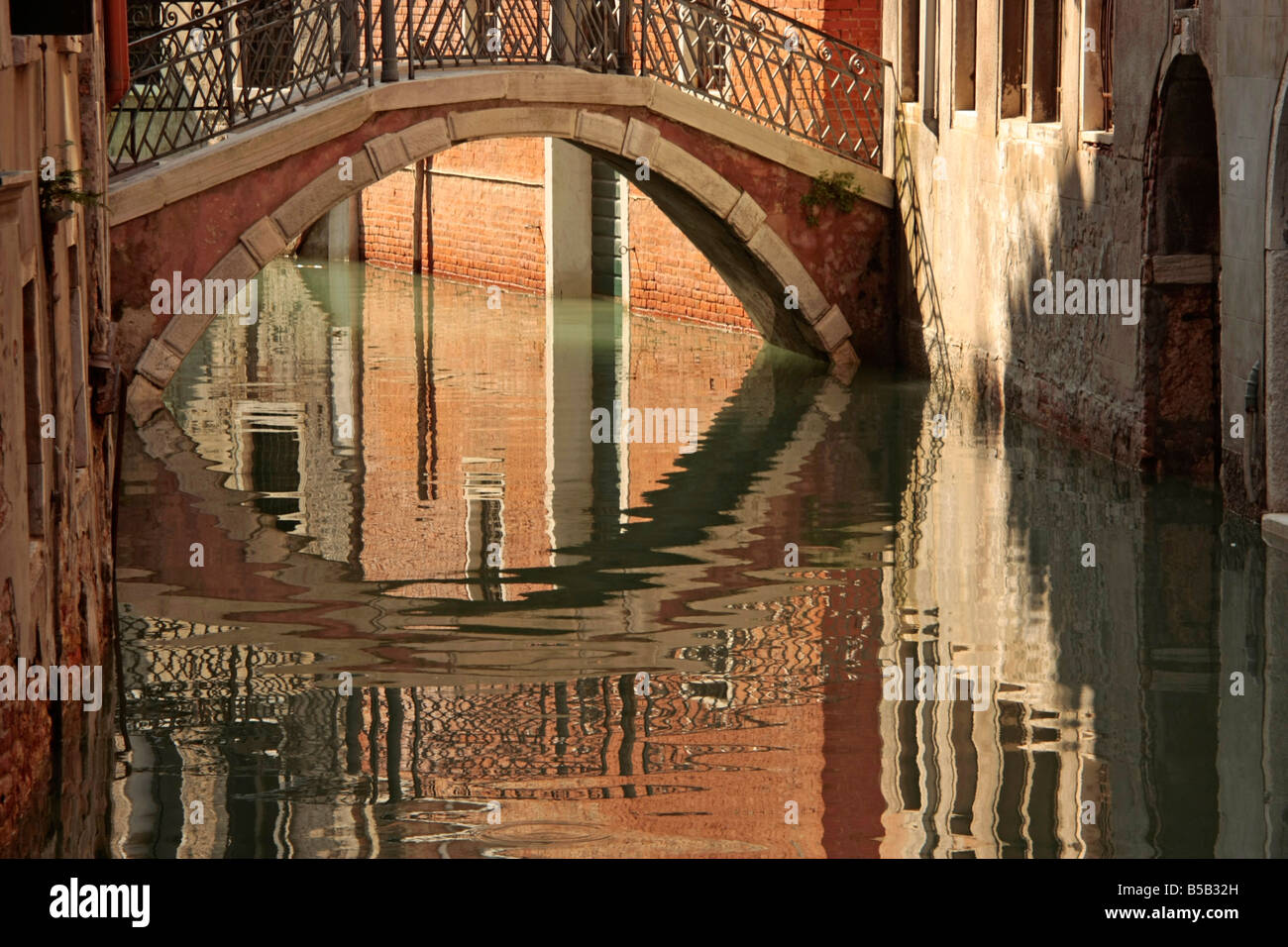 bridge reflected in a small canal in Venice Italy Venice Italy Stock ...