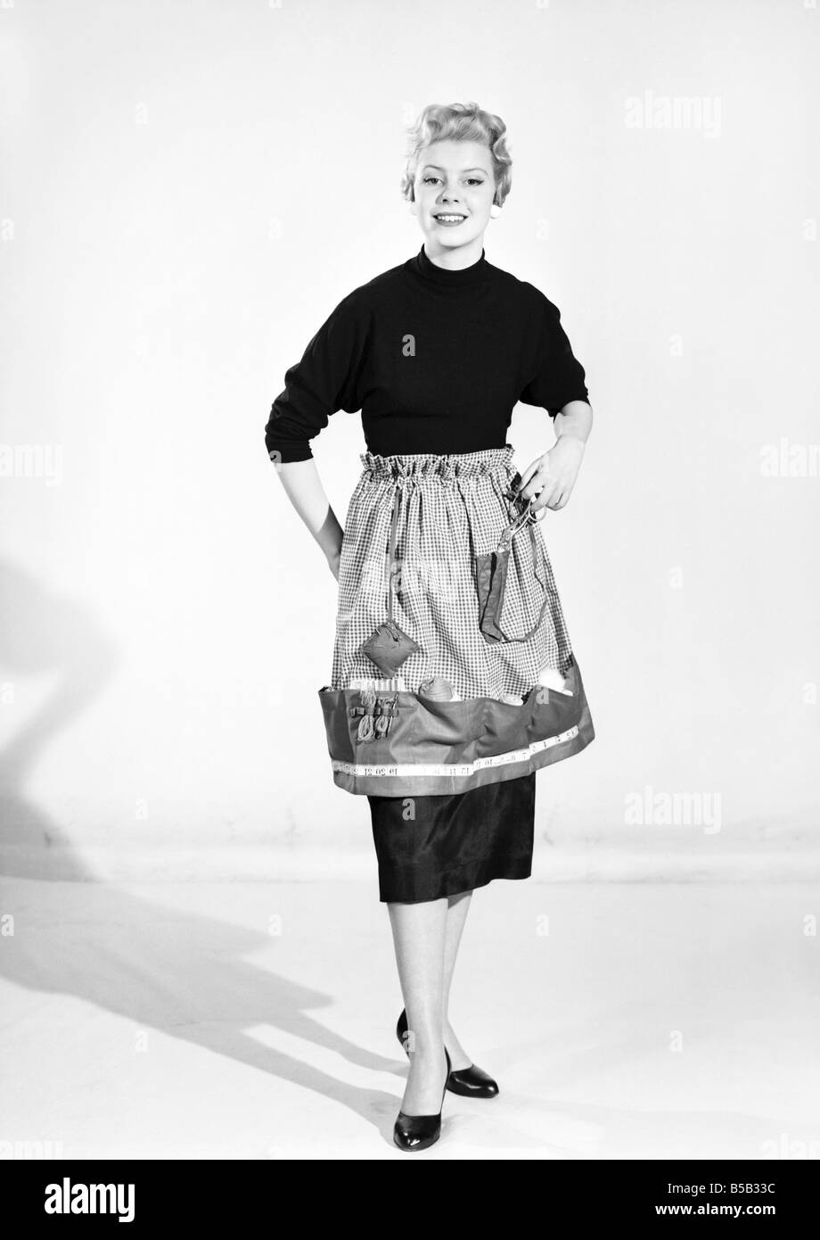 Woman wearing Dutch apron that converts into a bag. 1955 Stock Photo ...