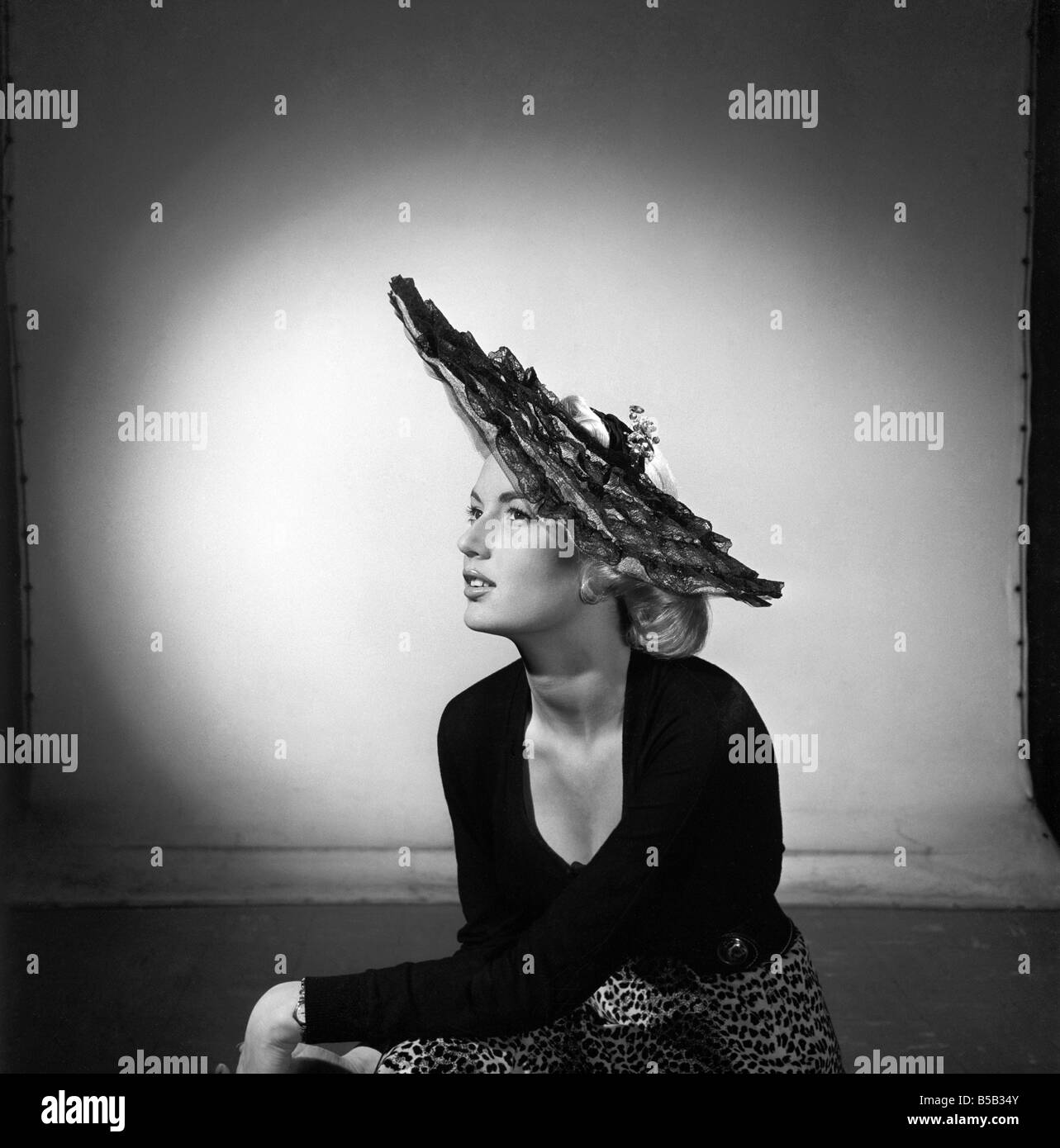 Woman modelling the latest 1956 hat fashions in the Reveille studios ...