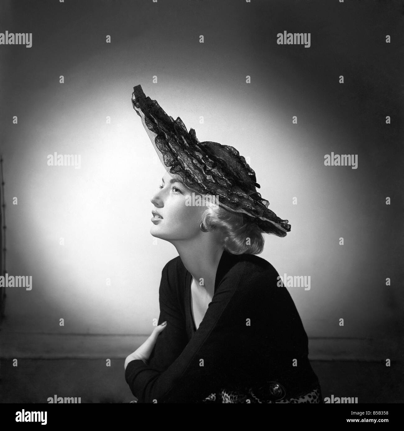Woman modelling the latest 1956 hat fashions in the Reveille studios ...