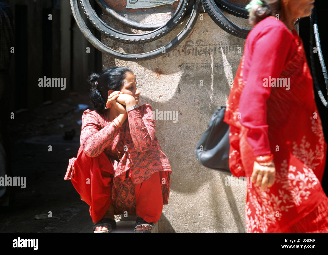 Indian women crouching on step, red Sari, India Stock Photo - Alamy