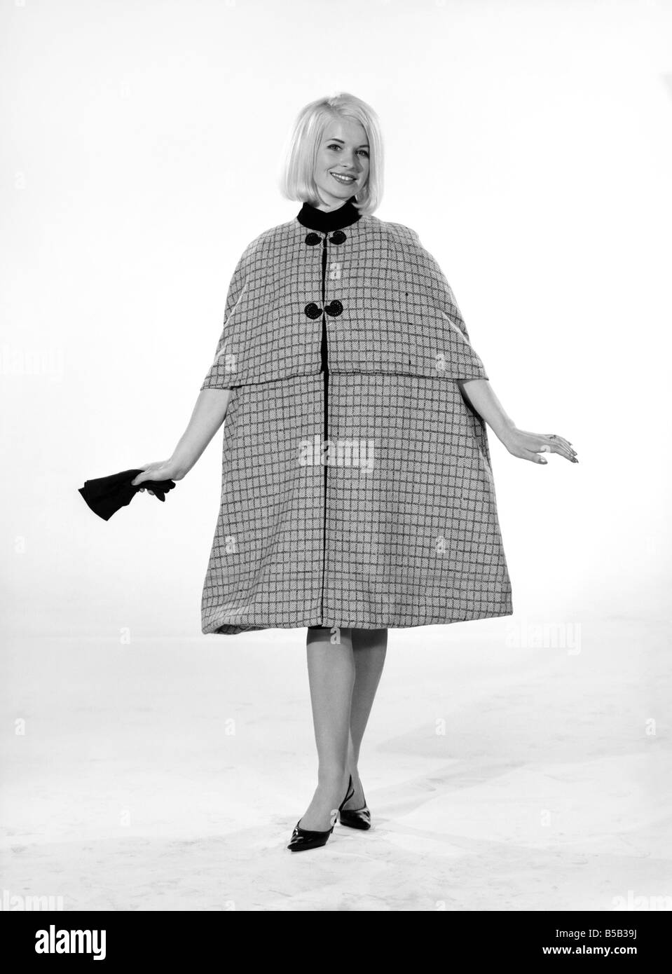 Model Vyvyan Dunbar wearing check cape which can be worn either full ...