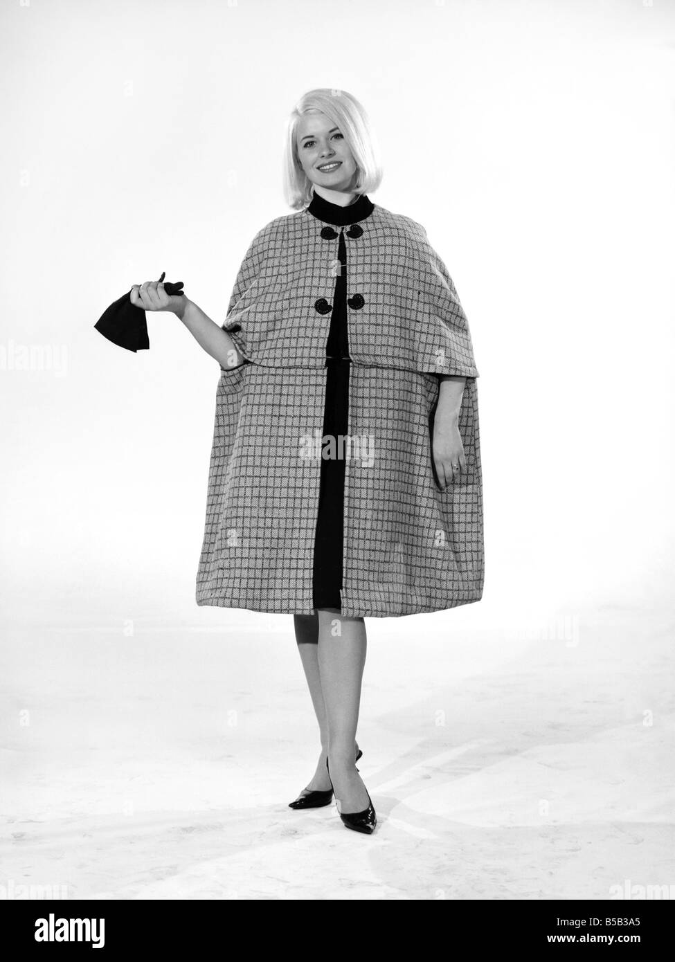 Model Vyvyan Dunbar wearing check cape which can be worn either full ...