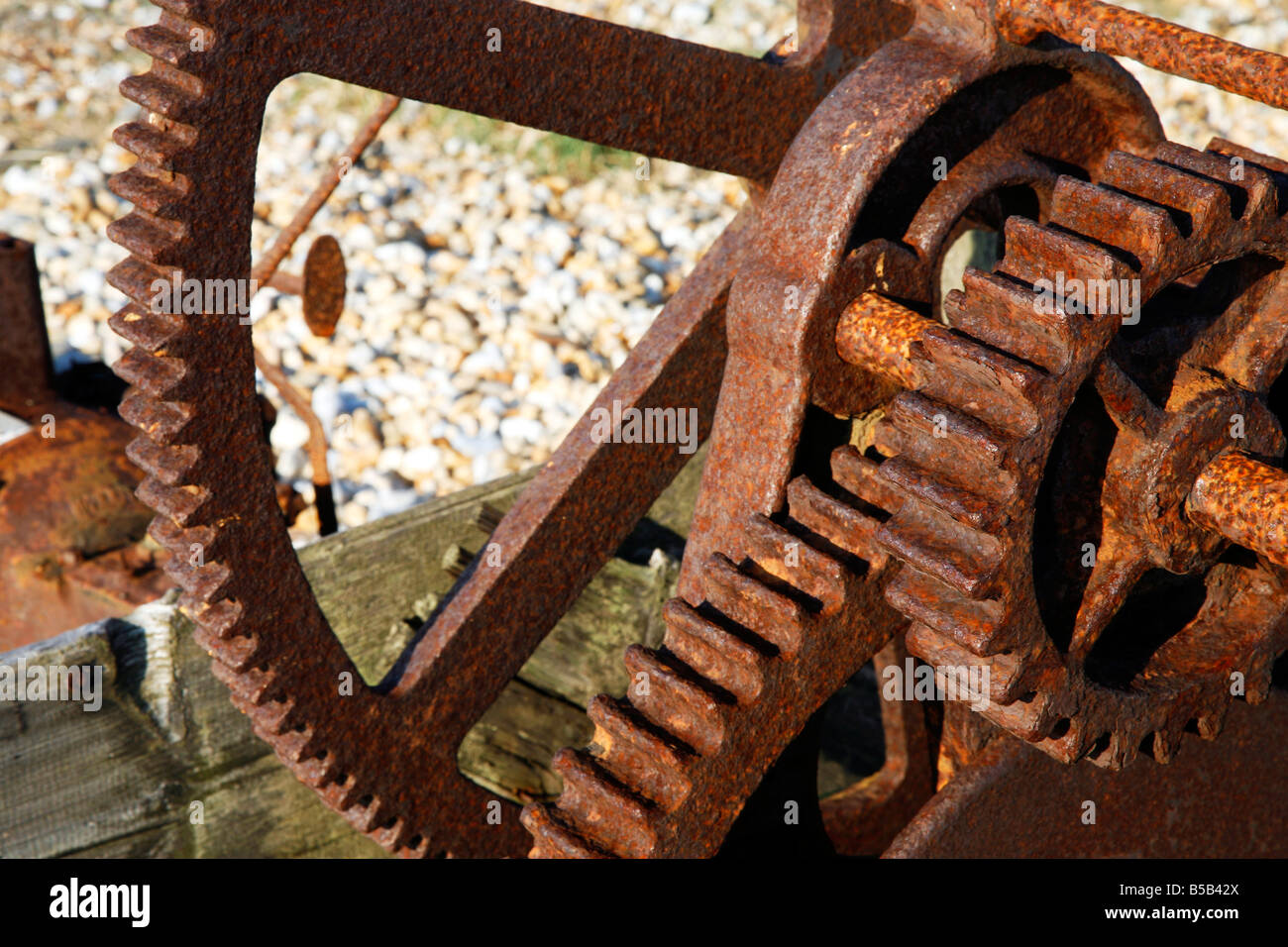 old rusty metal cog, Dungeness, Kent Stock Photo - Alamy
