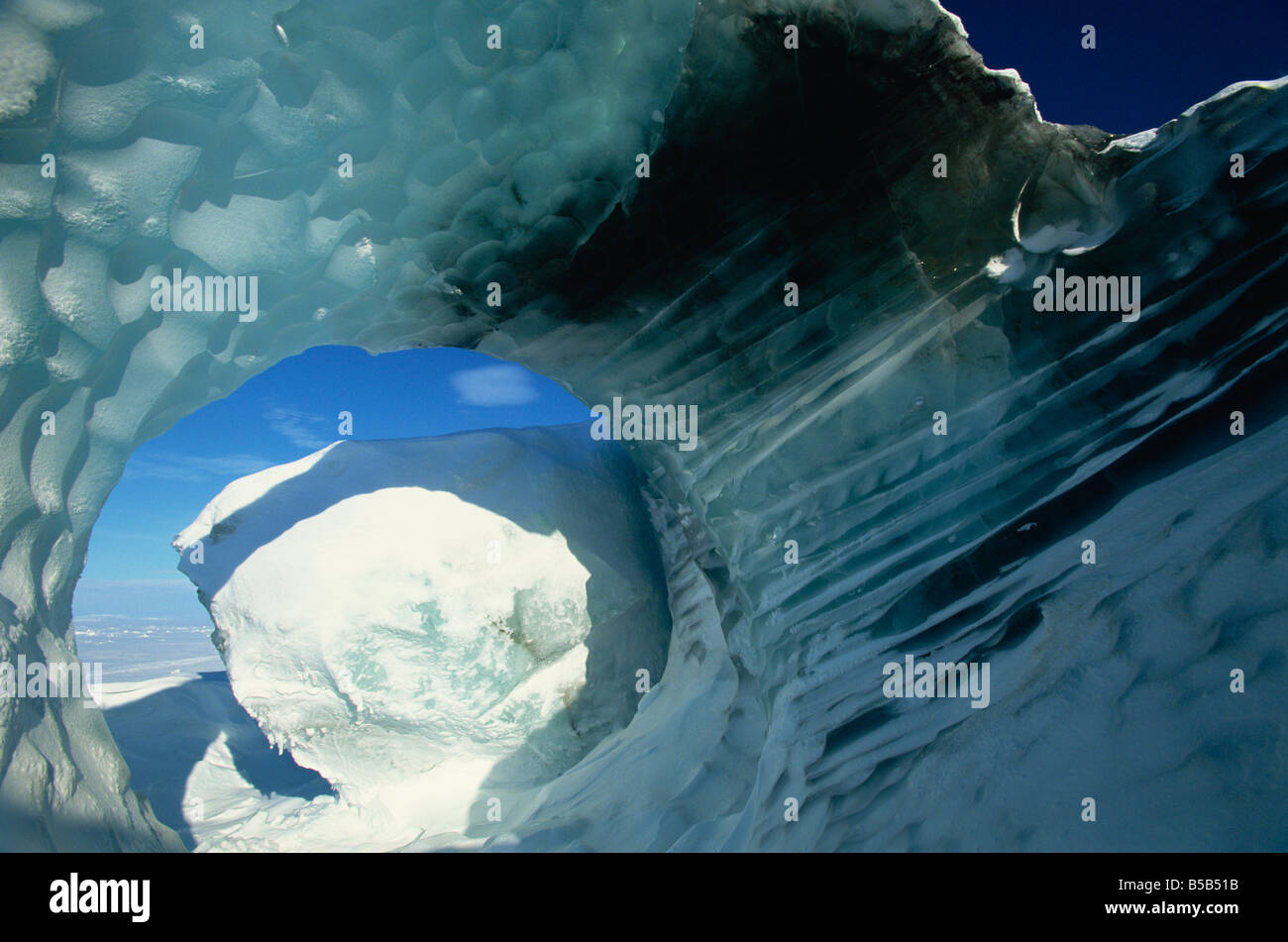 Glacial meltwater tunnel in iceberg showing sculpted water flow ...