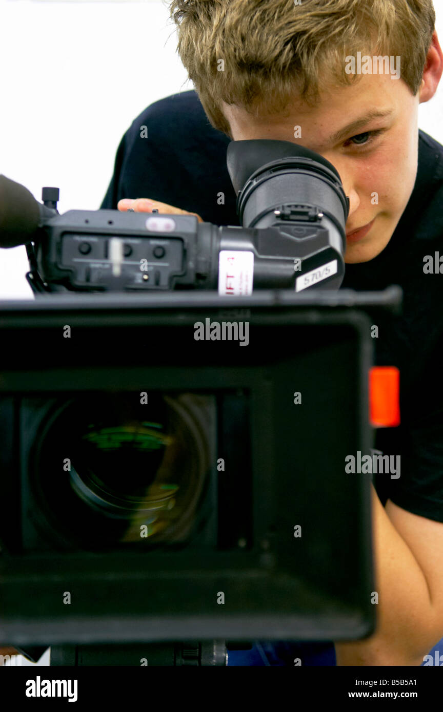 A teenage boy with a film camera in a studio Stock Photo - Alamy