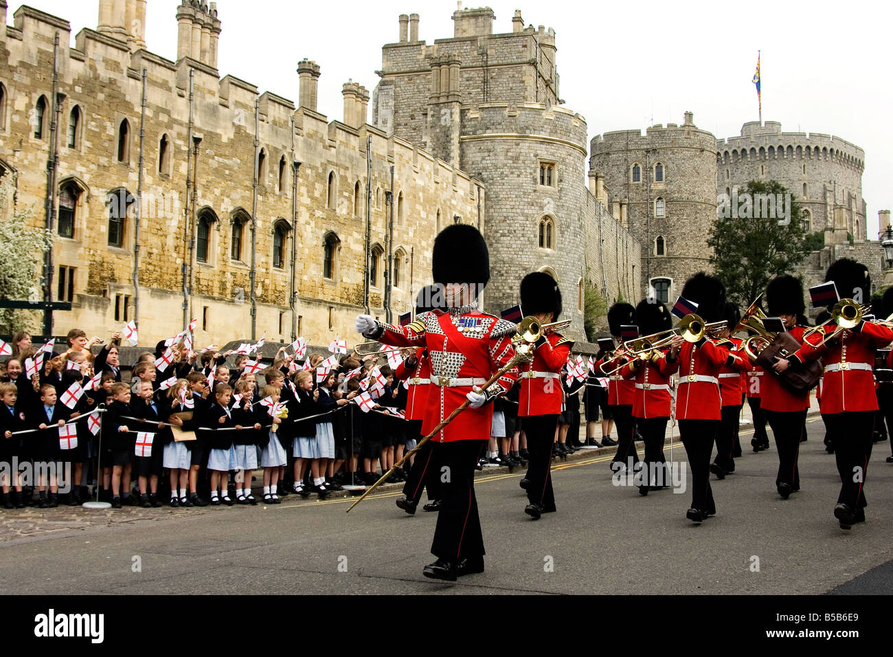 The military band of The Irish Guards marches past cheering school ...