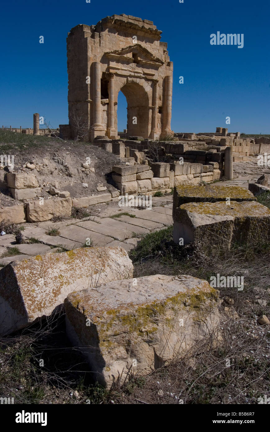 East-west road, with Arch of Trajan behind, Roman ruins of Makhtar ...