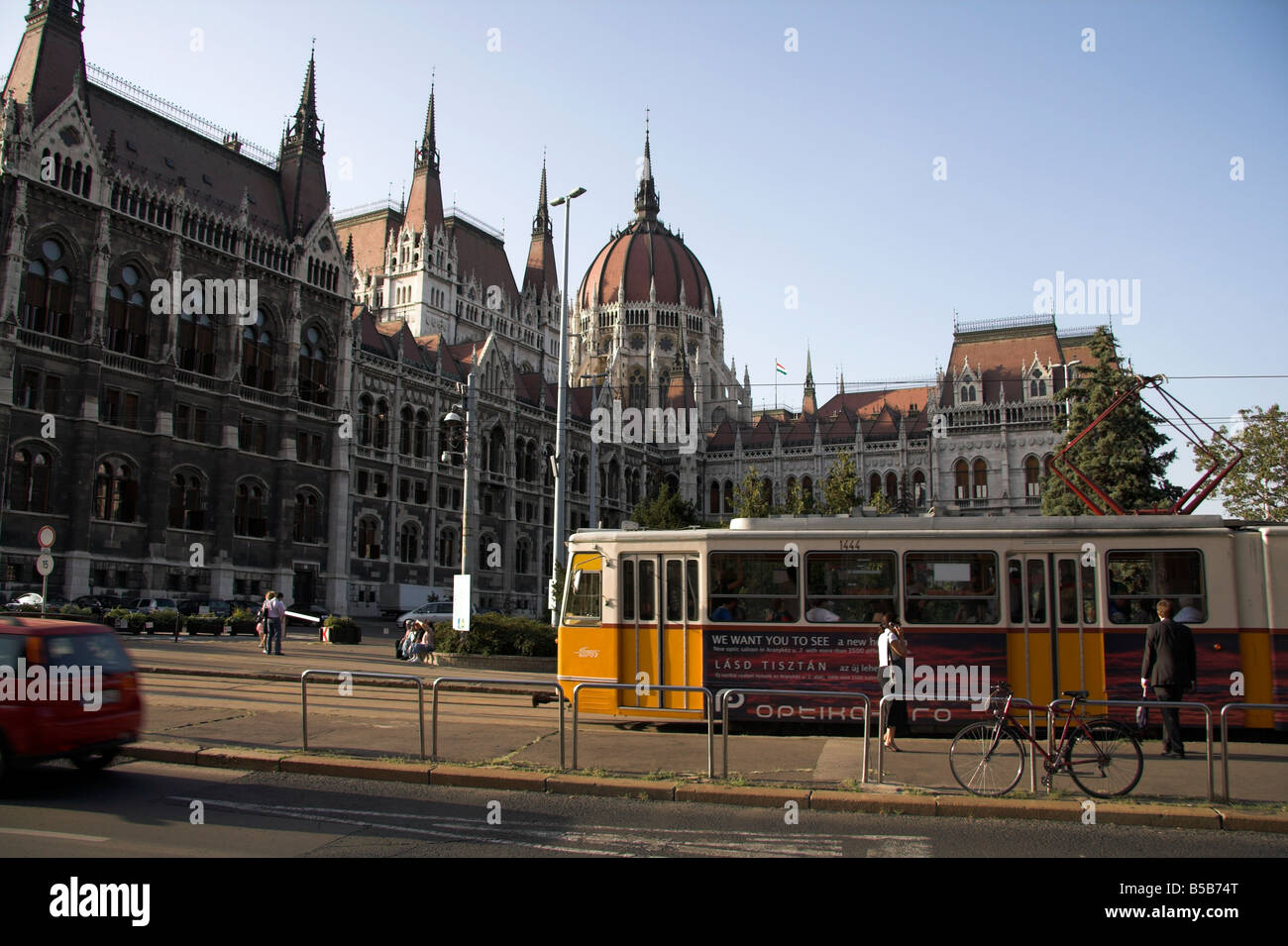 Yellow tram outside the Hungarian Parliament building, Pest, Budapest ...