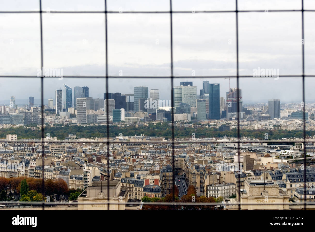 Financial district of Paris trough a grid from the fence of the Eiffel ...